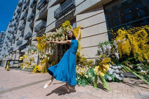 Beautiful Asian Ballerina Dances Against The Background Of A Building