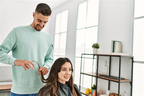Young Hispanic Stylist Man Cutting Woman S Hair Using Scissors At