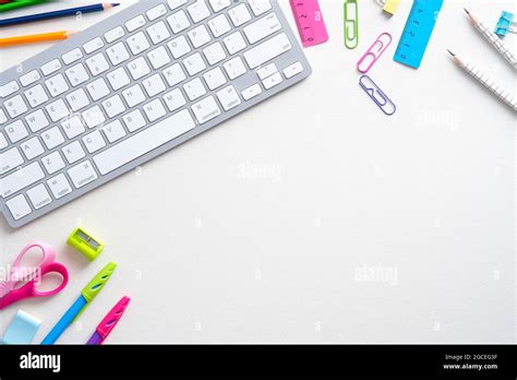 Flat Lay School Supplies And Computer Keyboard On White Background