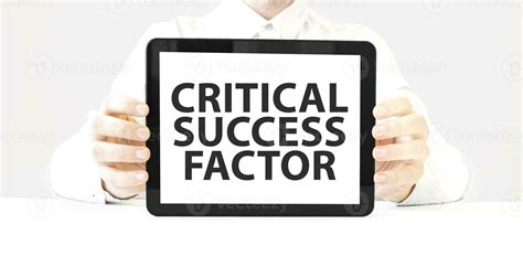 Text Critical Success Factor On Tablet Display In Businessman Hands On