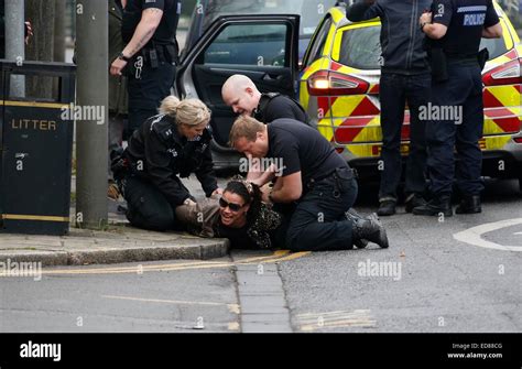A Woman Is Restrained And Arrested By Police For Being Drunk And