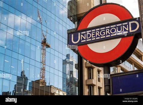 London Underground Tube Station Sign With A Construction Crane And City