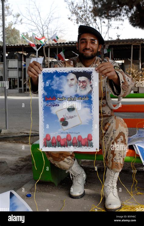 An Iranian Soldier Shows A Poster Symbolising The Dead Soldiers At