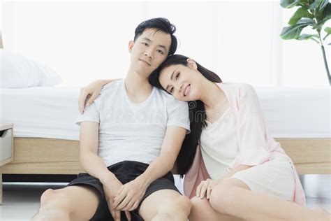 Couple In Pajamas Sit On Floor In Bedroom Stock Image Image Of Model