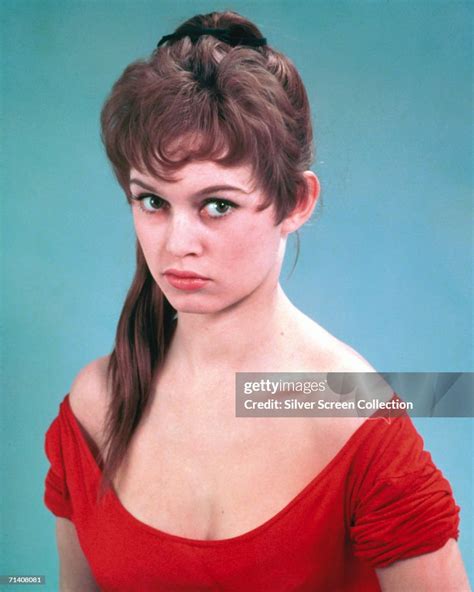 French Actress Brigitte Bardot Wearing A Low Necked Red Dress Circa