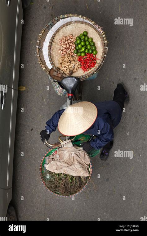 Street Vendor With Round Baskets Of Fruit And Vegetables On Bicycle