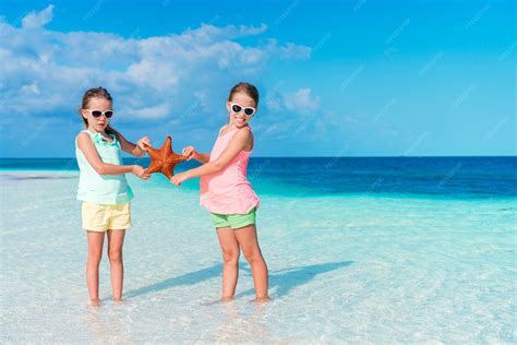 Premium Photo Two Little Happy Girls Have A Lot Of Fun At Tropical