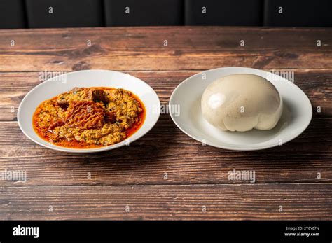 A Traditional African Dish Featuring Egusi Soup With Assorted Meat And