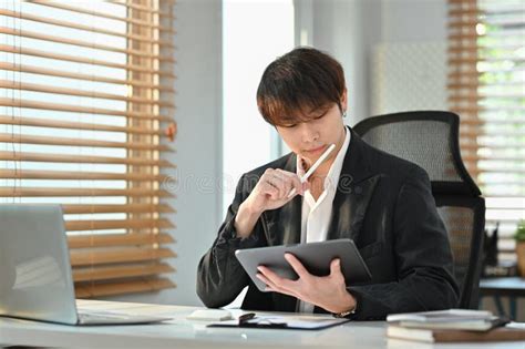 Image Of Financial Analyst In Elegant Suit Sitting At His Workstation