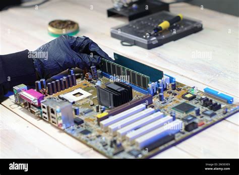 Inserting Ram Into Motherboard From Computer On Table And Gray Background Stock Photo Alamy