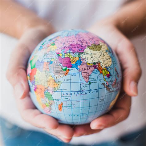 Premium Photo Close Up Of Hand Holding Globe