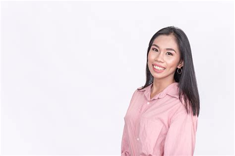 A Cheerful And Upbeat Filipina In A Pink Blouse Posing Against A White