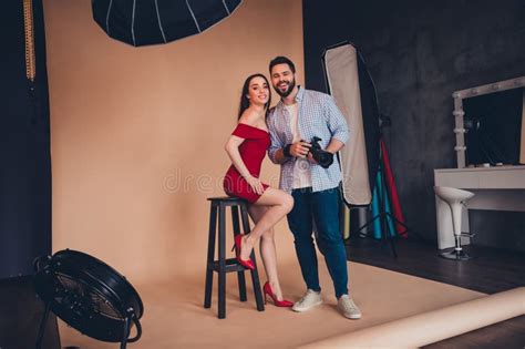 Fashion Couple Young Woman In Dress And Guy Take Photosession In Modern