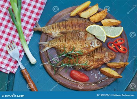 Fried Fish Served On A Wooden Plate With Potato Stock Image Image Of
