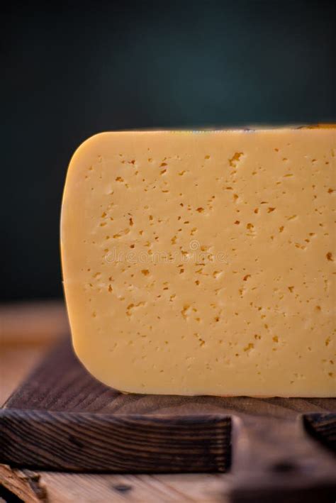 Medium Hard Cheese Gouda Edam On Wooden Board On Sunlight Table