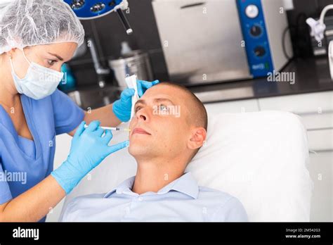Man Receiving Facial Contouring Injections In Cosmetology Clinic Stock