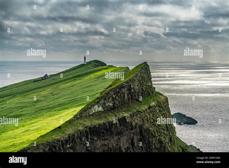 The Lighthouse On Mykines Island Under The Clouds Faroe Islands Stock
