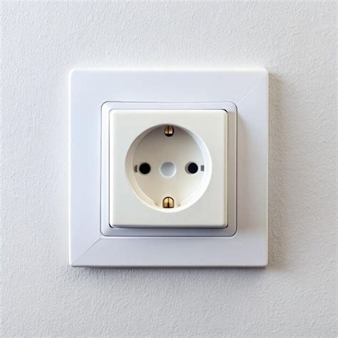 Standard Electrical Socket Installed On A Clean White Wall In A Modern