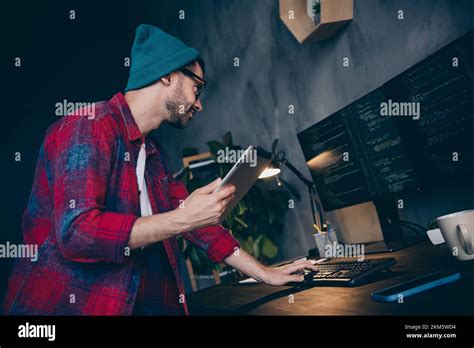 Photo Of Serious Busy Coder Dressed Hat Glasses Connecting Ereader To Modern Gadget Indoors