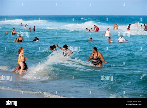 Beach Goers Wading And Playing In The Surf Pensacola Beach Florida