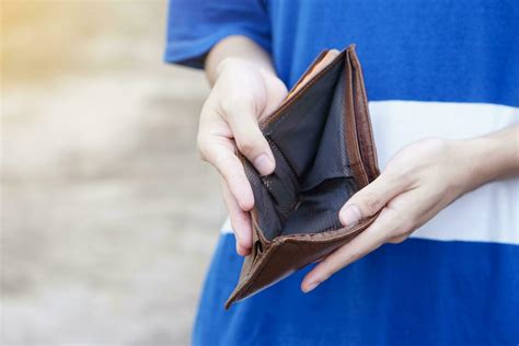 close up hands hold empty wallet with no money concept poor bad