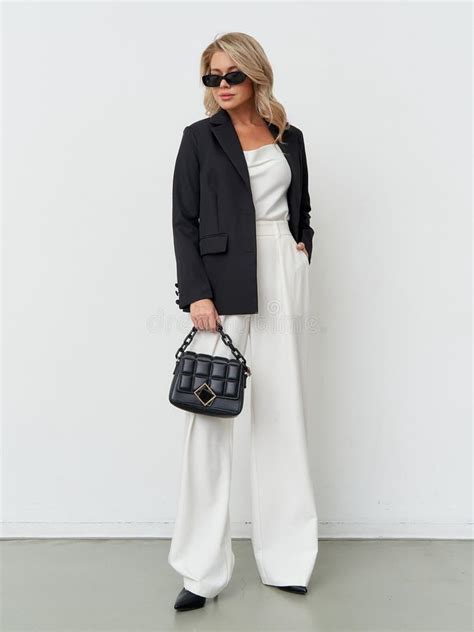 Elegant Model Posing In A Stylish Black And White Ensemble Within A