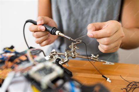 Premium Photo Man Welding The Wire For Assemble Of Drone