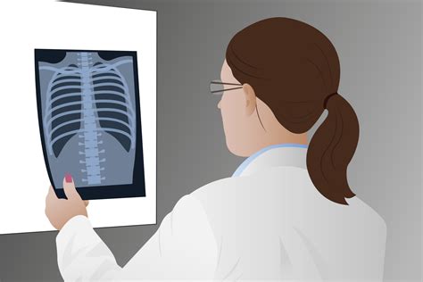A Female Doctor Examines A Chest X Ray Of A Patient In The X Ray Department Of A Hospital