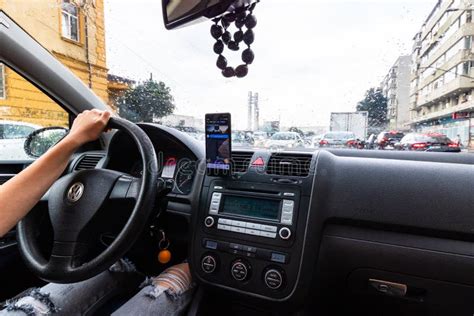 Using Waze Maps Application On Smartphone On Car Dashboard Driver Using Maps App For Showing