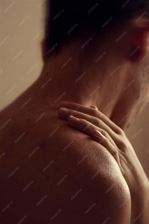 Premium Photo Rear View Of Shirtless Men Touching Shoulder