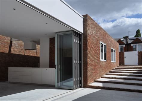 Jack Woolleys Spiral House Hides Itself Behind A Brick Wall