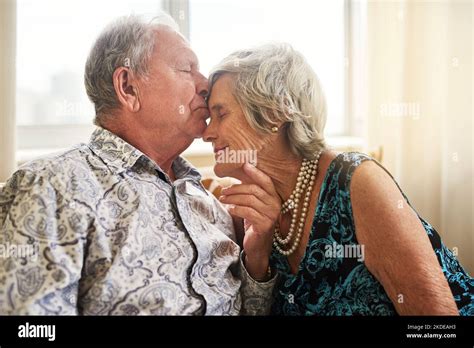 Their Love Grows More Precious As Time Goes By A Senior Man Tenderly Kissing His Wifes Forehead