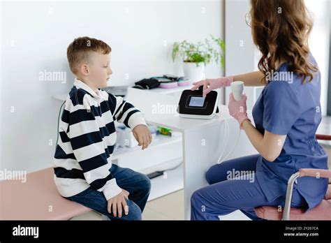 Boy Testing Breathing Function By Spirometry In Doctors Office