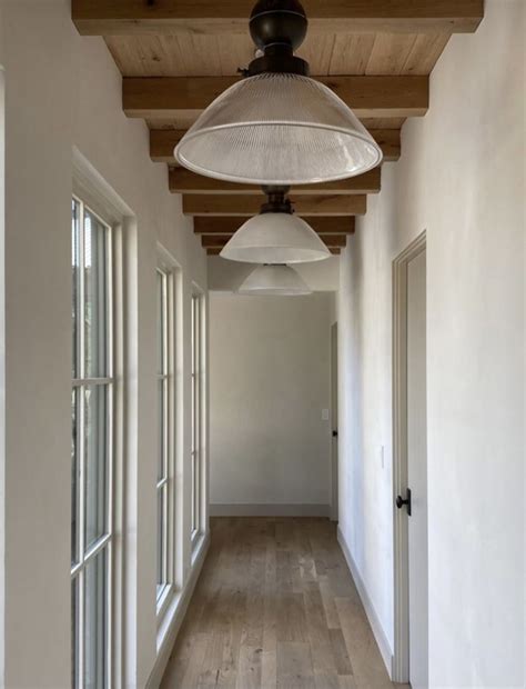 Cozy Cottage Hallway With Wood Floors And Ceiling Lights