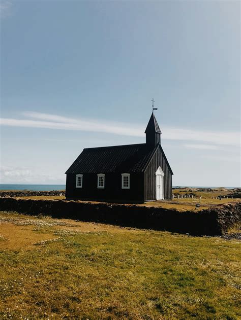 A Black Church With A Steeple On A Grassy Hill Photo Free Grey Image