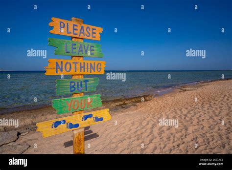 View Of Sign Reading Please Leave Nothing But Your Footprints On The