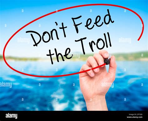 Man Hand Writing Dont Feed The Troll With Black Marker On Visual