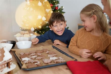Premium Photo Siblings Having Fun After Baking Gingerbread Cookies