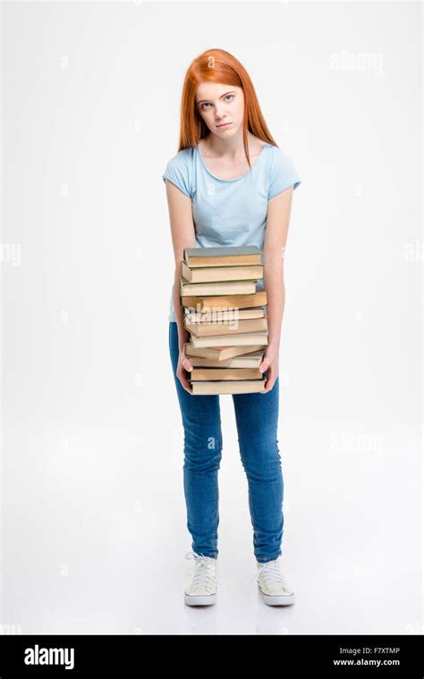 Tired Exhausted Young Redhead Woman Standing And Holding Stack Of Books