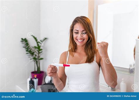 Finally Pregnant Young Women Looking At Pregnancy Test And Smiling
