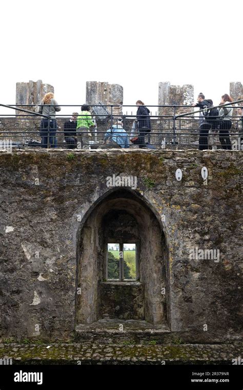 People Waiting In Line To Kiss The Blarney Stone At The Top Of Blarney