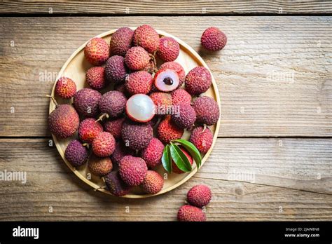 Lychee Frui With Green Leaf On Wooden Plate Background Top View Fresh