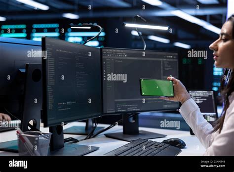 Programmer In Data Center Taking Break From Work Using Isolated Screen Mobile Phone To Relax