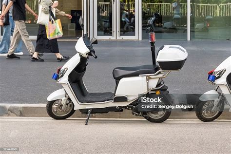 Police Moped Parked On City Street In Shanghai Near Busy Pedestrian