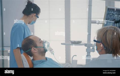 Oral Care Worker Giving Oxygen Mask With Anesthesic To Patient Dentist