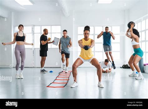 Multiethnic Group Of Sportive People Doing Functional Workout In