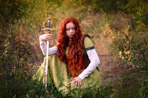 Beautiful Red Haired Warrior Queen Woman With A Sword In The Deep Forest Stock Image Image Of