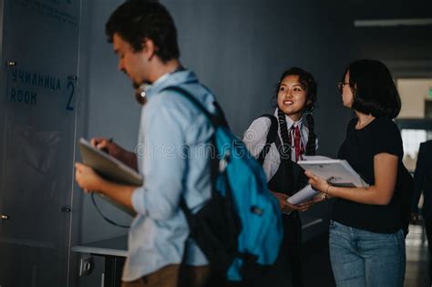Students Socializing In A School Hallway Between Classes Stock Image