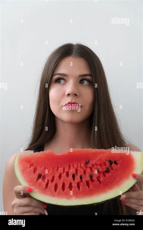 The Girl Is Holding A Big Watermelon In Her Hands The Brunette Is
