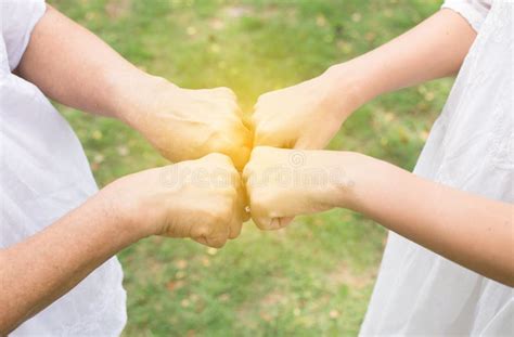 Hand Of Asian Female Elderly Giving Fist Bump To Hands Young Women At